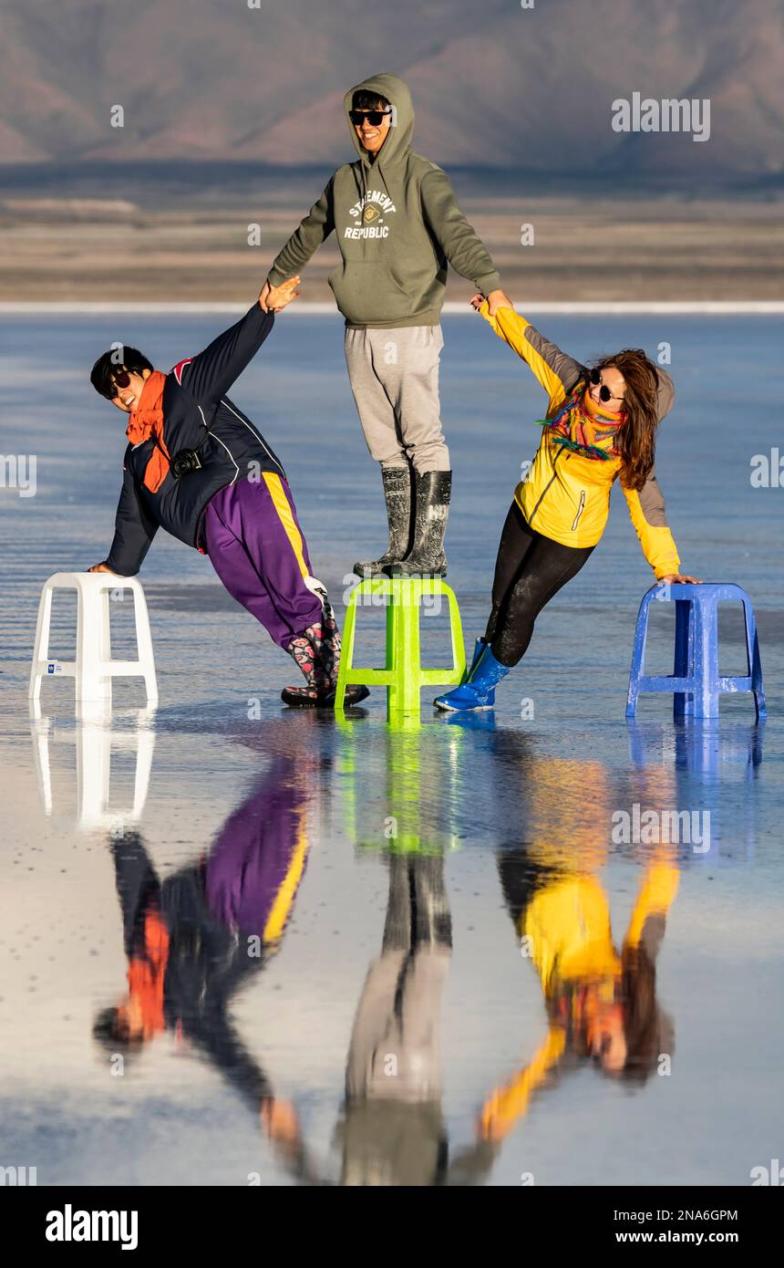 Tourists posing in the reflection during the wet season (December ...
