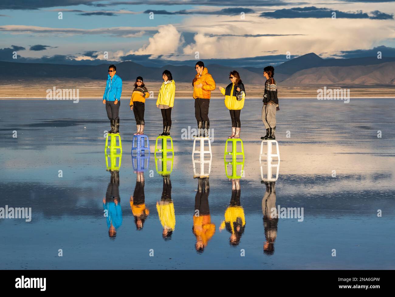 Tourists posing in the reflection during the wet season (December ...