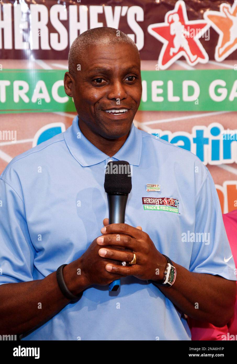 Olympic legend Carl Lewis (C) celebrates HERSHEY'S Track & Field Games ...
