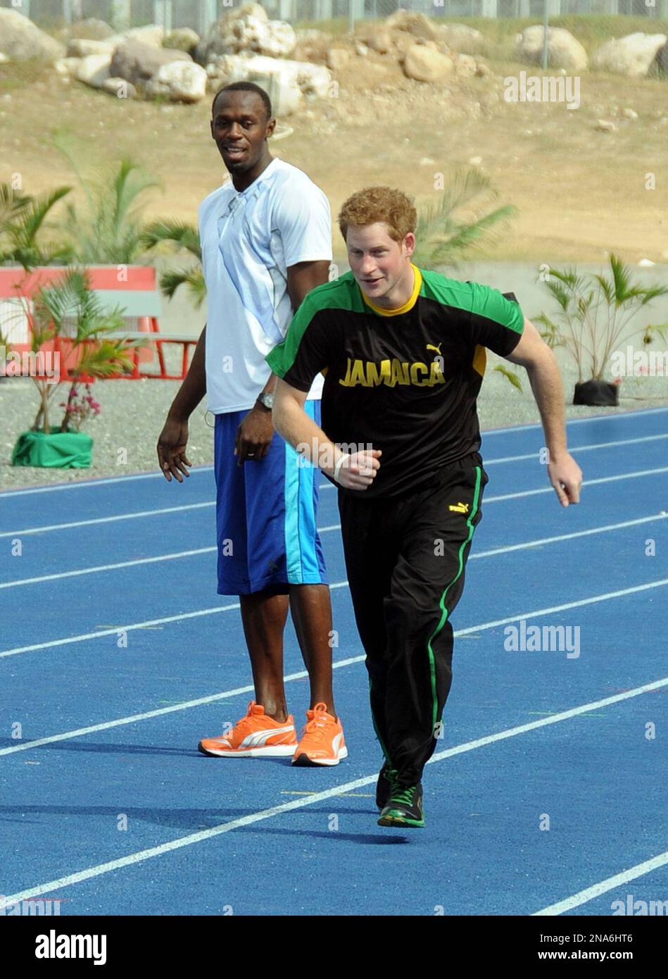Britain's Prince Harry runs as Olympic sprint champion Usain Bolt ...