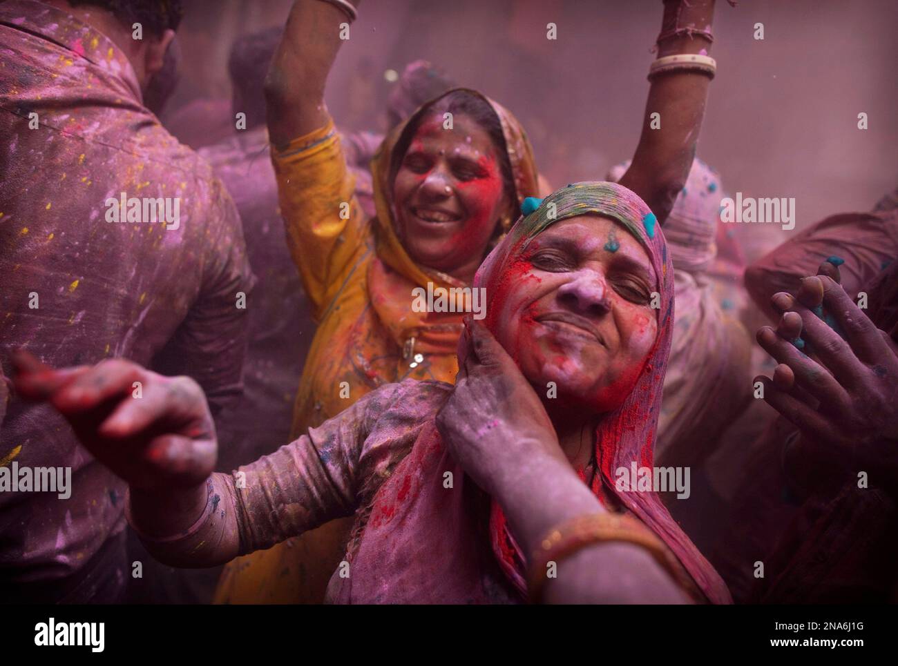 Hindu devotees smear color on each other while celebrating "Holi," the ...