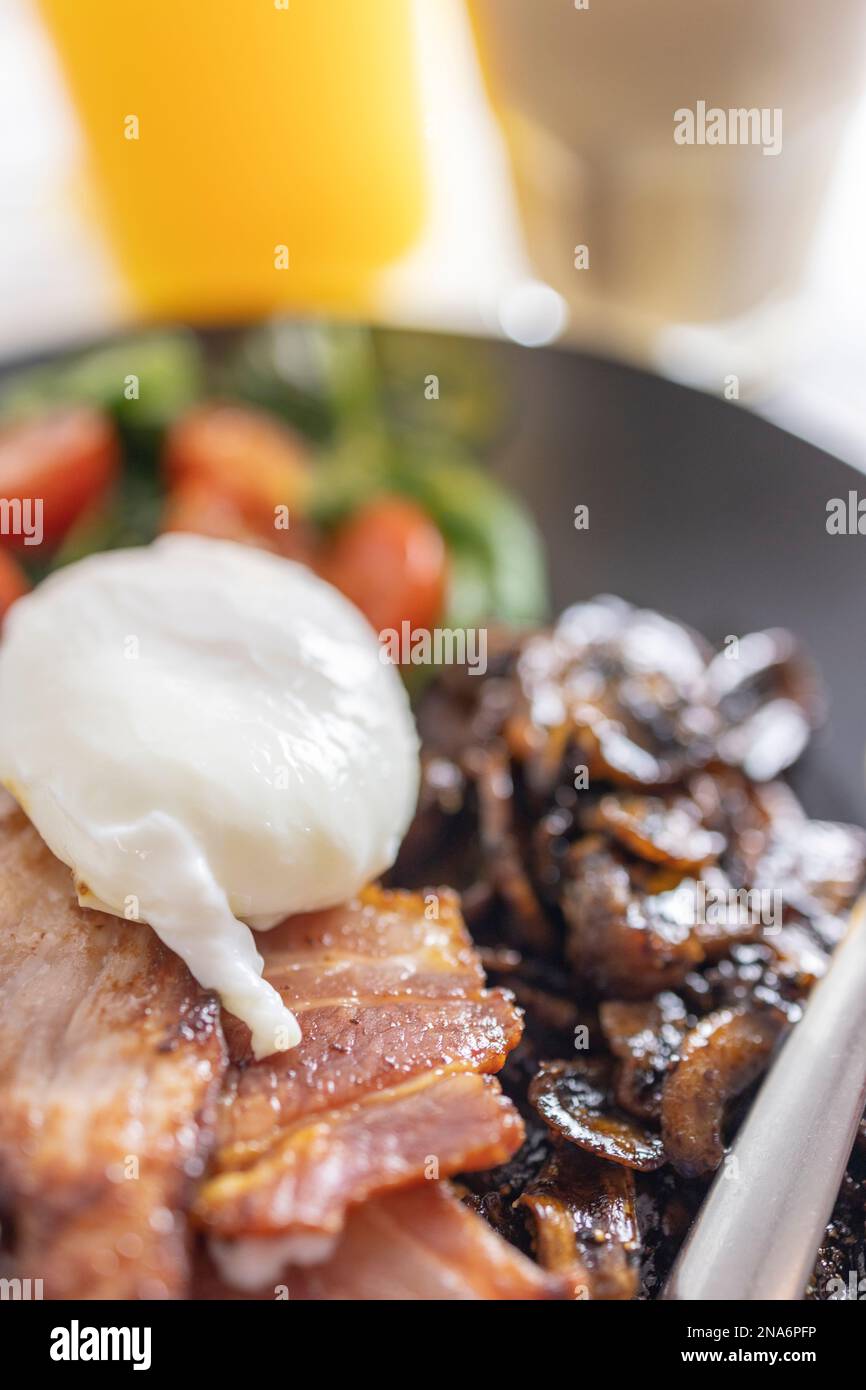 Big breakfast fry-up poached eggs with bacon on toast with fried tomato ...