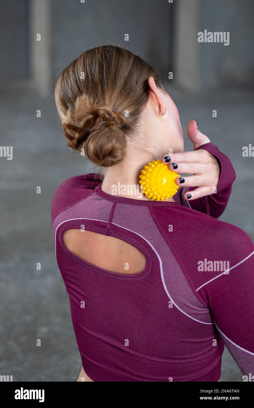 The athlete does a relaxing massage of the neck and back with the help ...