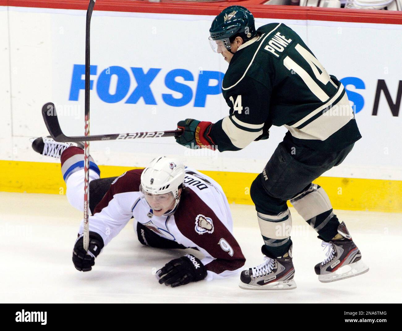 Colorado Avalanche's Matt Duchene, left, hits the ice from a check by ...