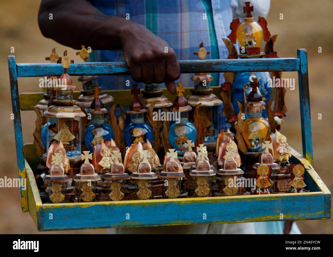 In this July 7, 2010 photo, a vendor sells small statues of Cuba's ...