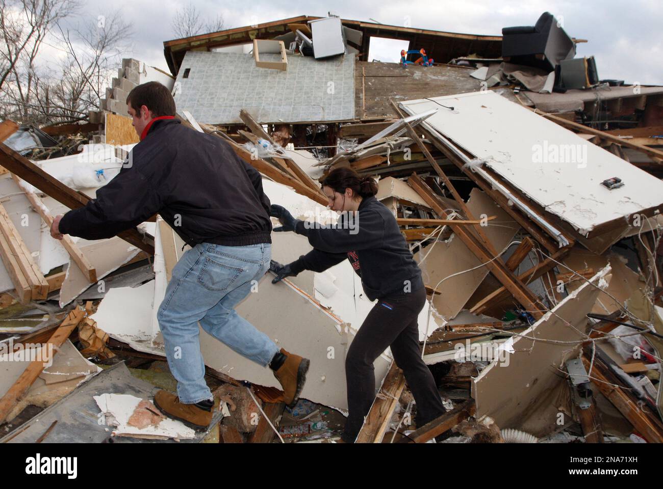 Bill and Stacy Loyd look for personal items at their house after it was ...