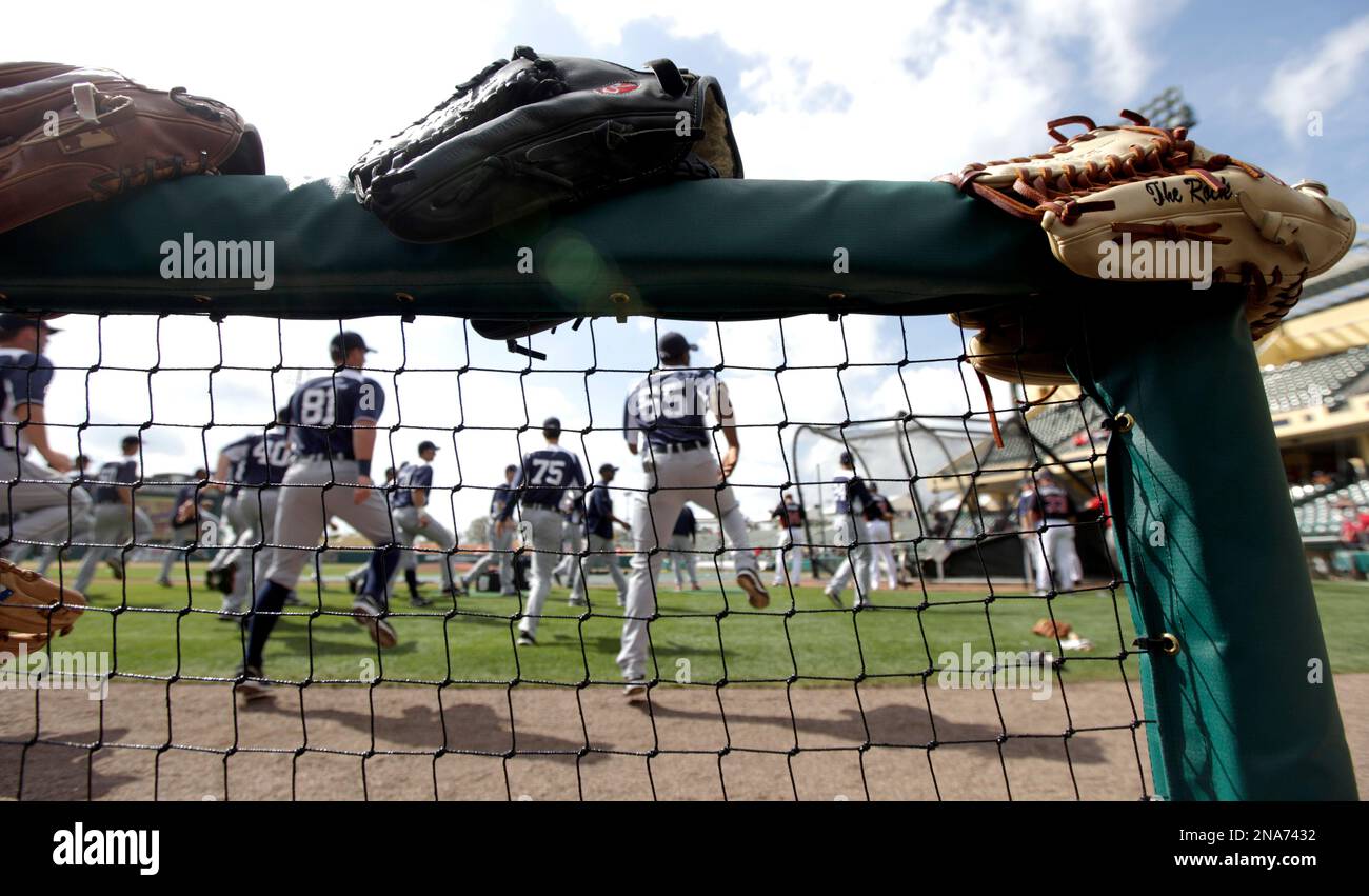 Members of the Detroit Tigers warm up prior to the start of a spring ...