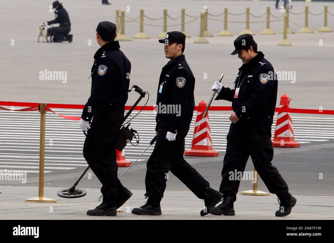 Chinese police officers checks the area before the opening session of ...