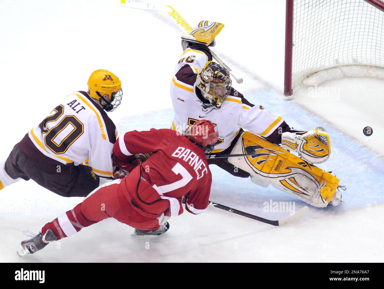 Wisconsin's Tyler Barnes (7) scores around Minnesota's Mark Alt and ...