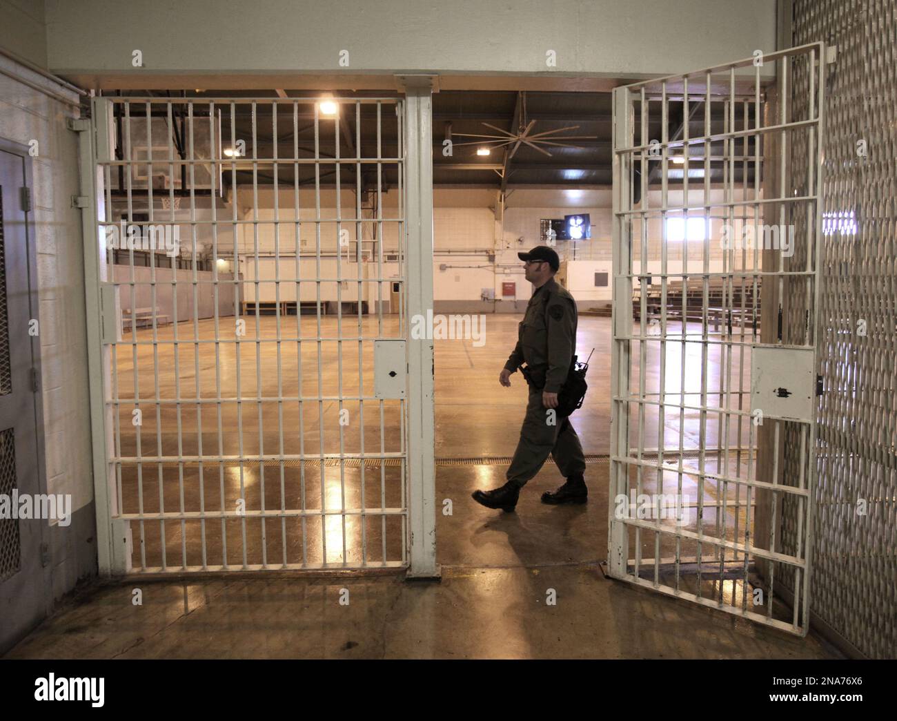 A correctional officer walks through a gymnasium that once held nearly ...
