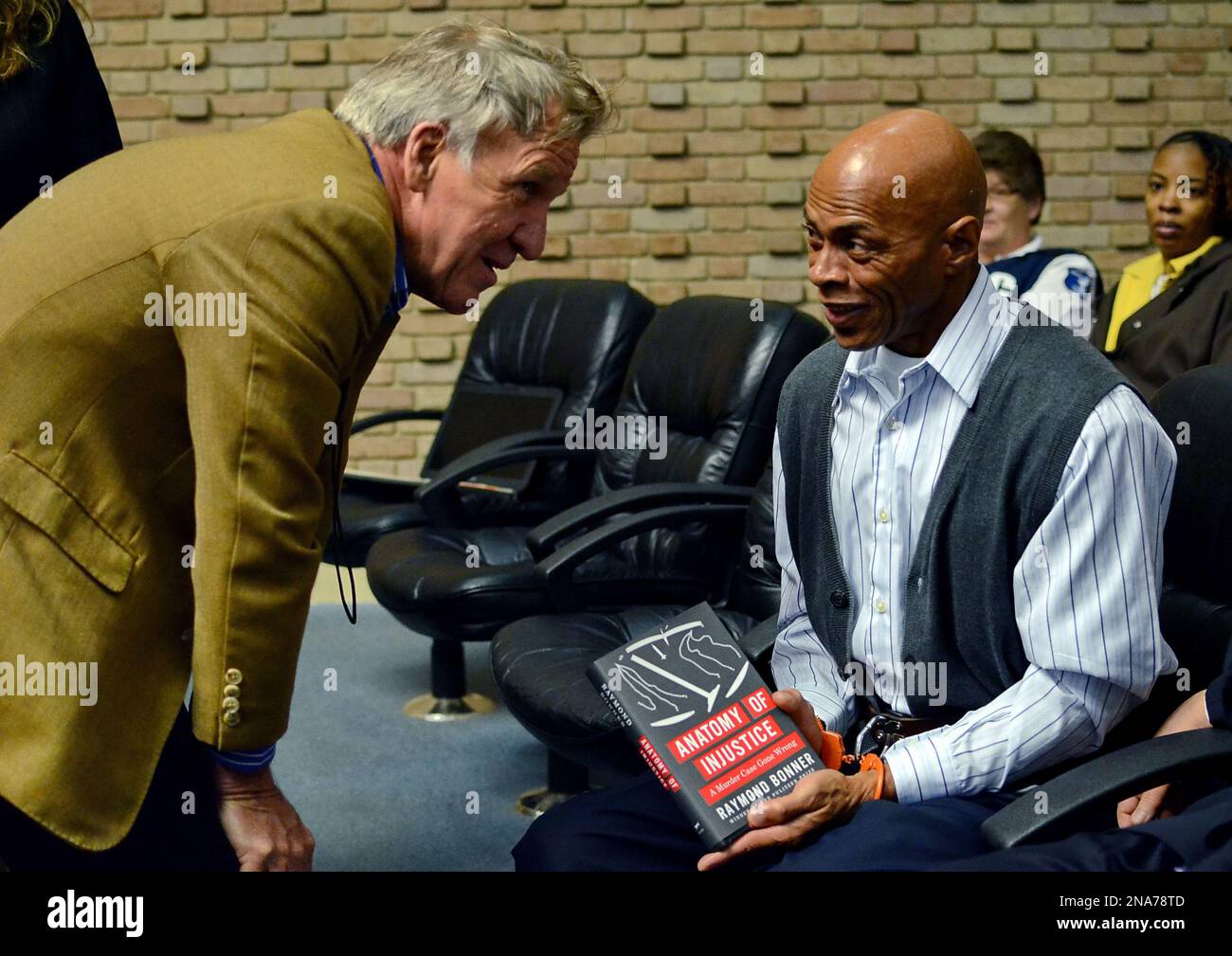 Author Raymond Bonner, left, speaks to Edward Lee Elmore before his ...