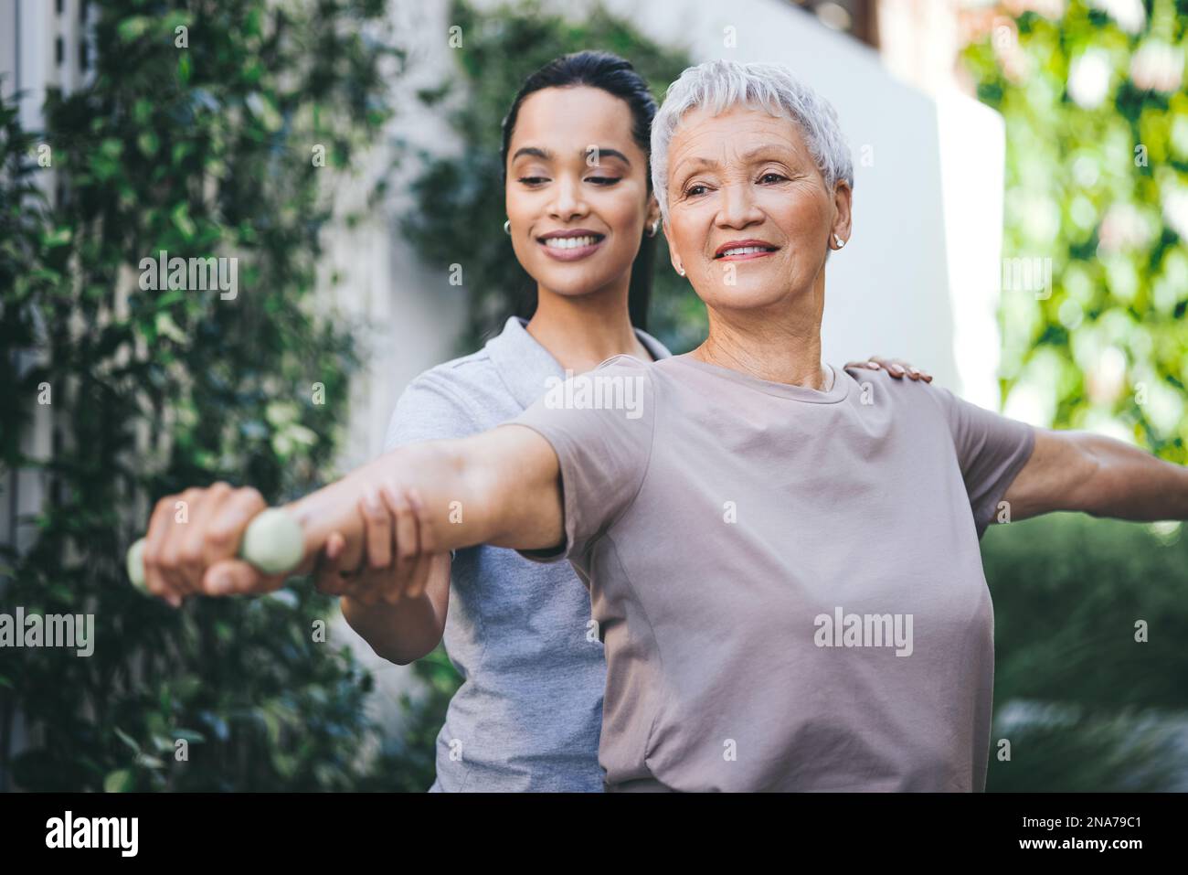 An unbreakable bond. an older woman lifting a dumbbell during a session ...