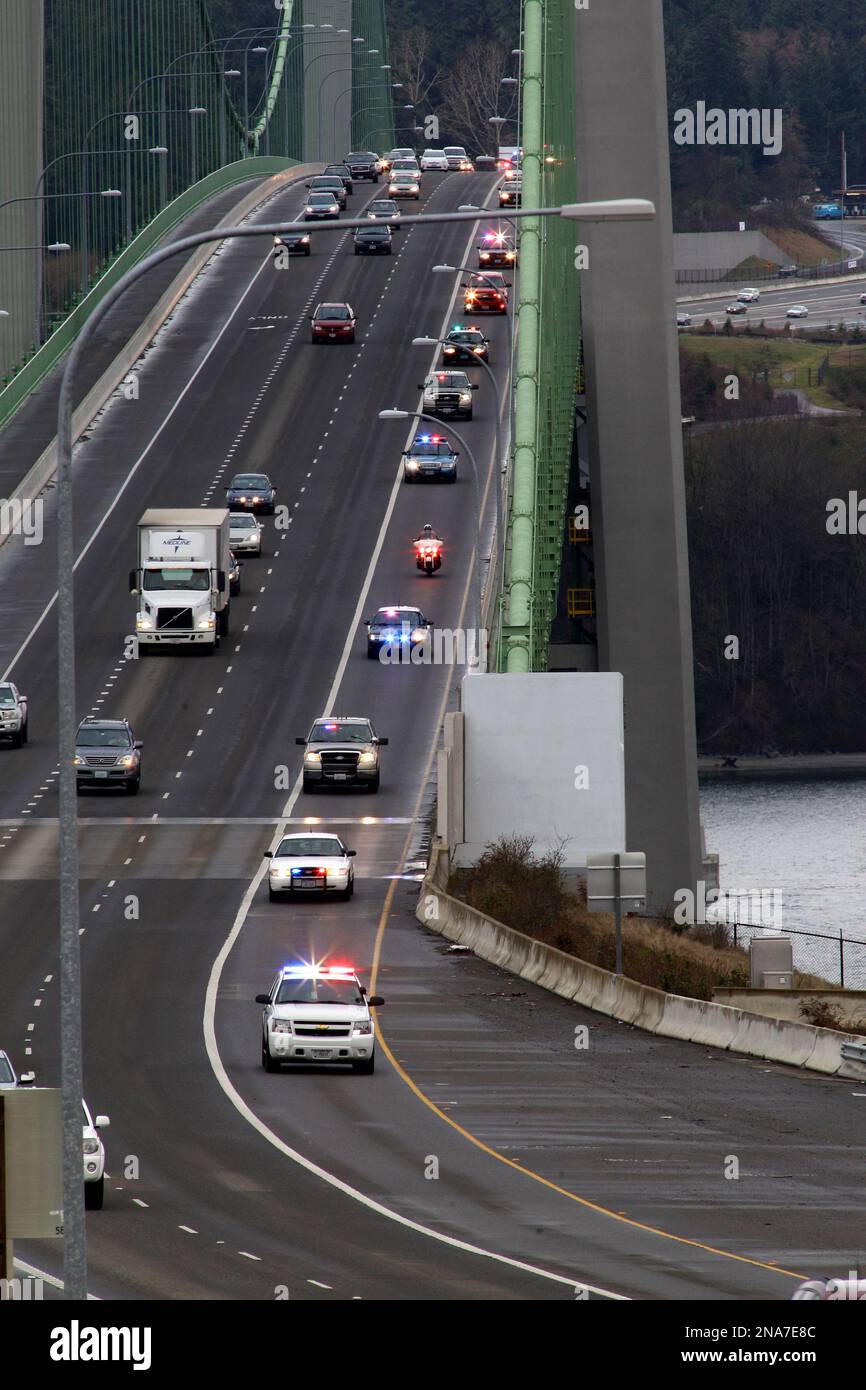 A procession of law-enforcement vehicles makes its way over the Tacoma ...