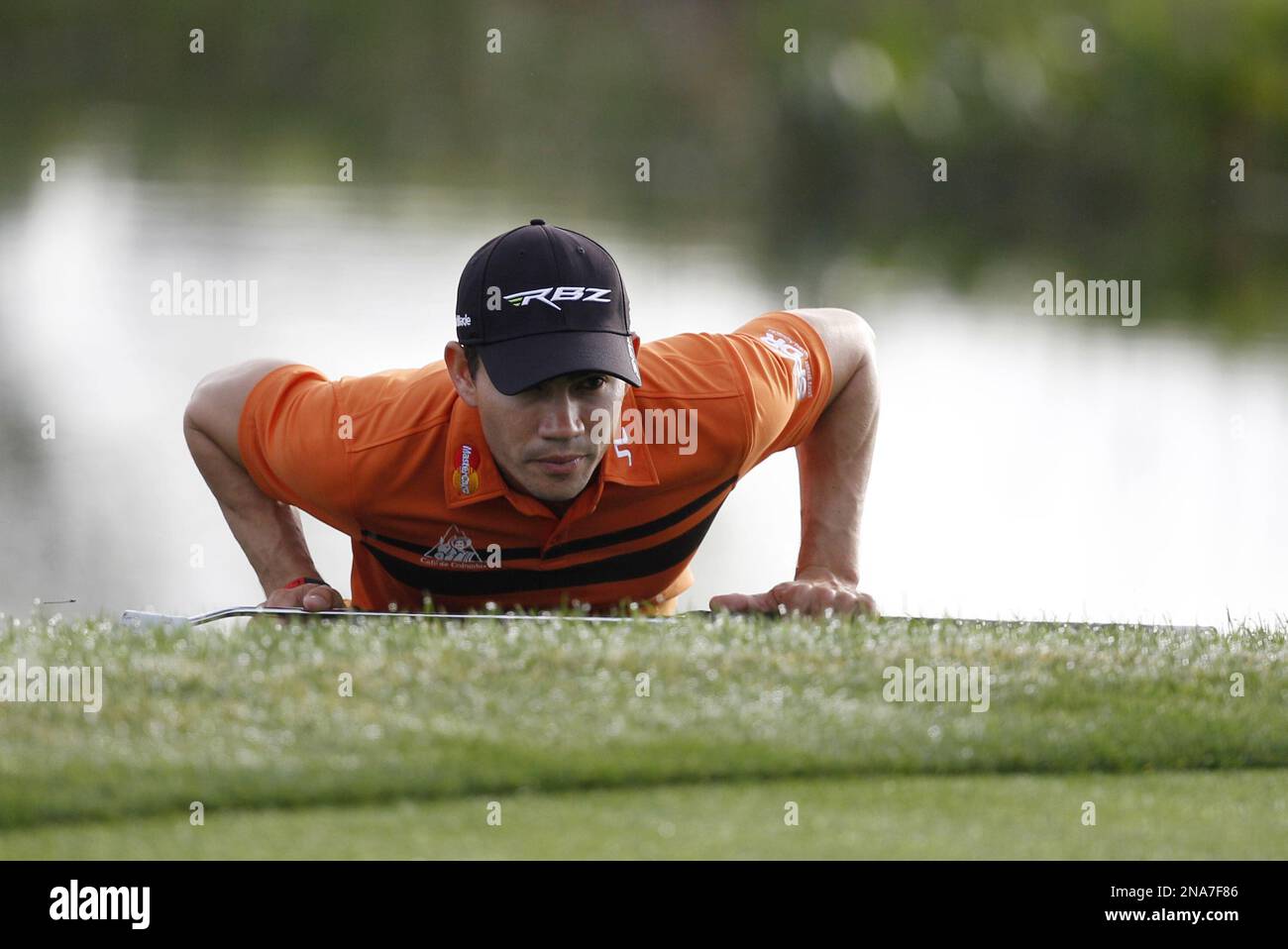 Camilo Villegas of Colombia lines up a putt on the 11th green during ...