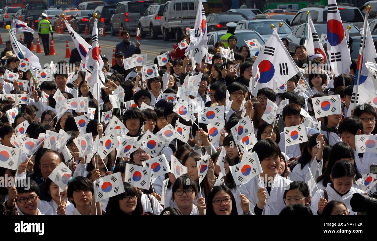 South Korean students wearing traditional Korean costumes march as they ...