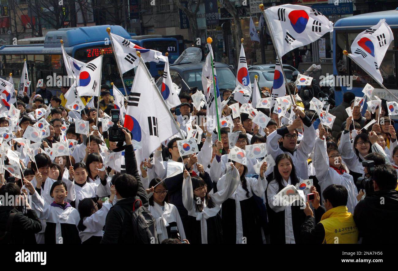 South Korean students wearing traditional Korean costumes shout slogans ...