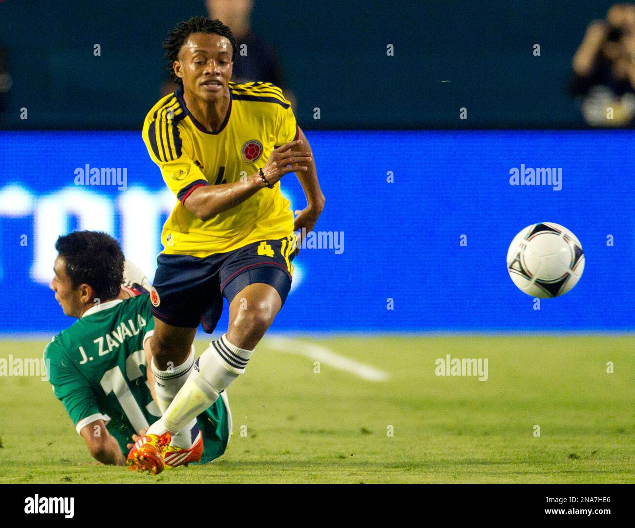 Colombia's Juan Guillermo Cuadrado (4) chases the ball ahead of and ...