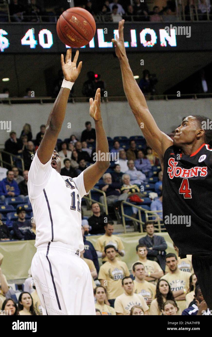 Pittsburgh's Ashton Gibbs, left, shoots over St. John's Moe Harkless (4 ...