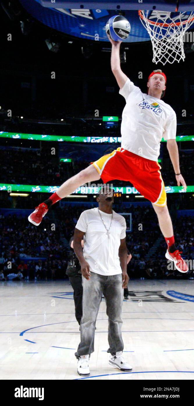 Houston Rockets' Chase Budinger (10) jumps over singer P. Diddy during ...