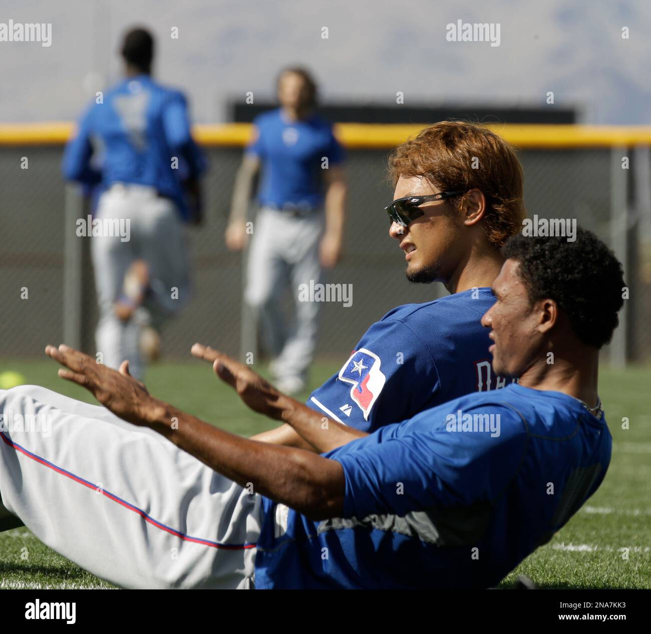 Texas Rangers pitchers Yu Darvish, of Japan, and Alexi Ogando, front ...