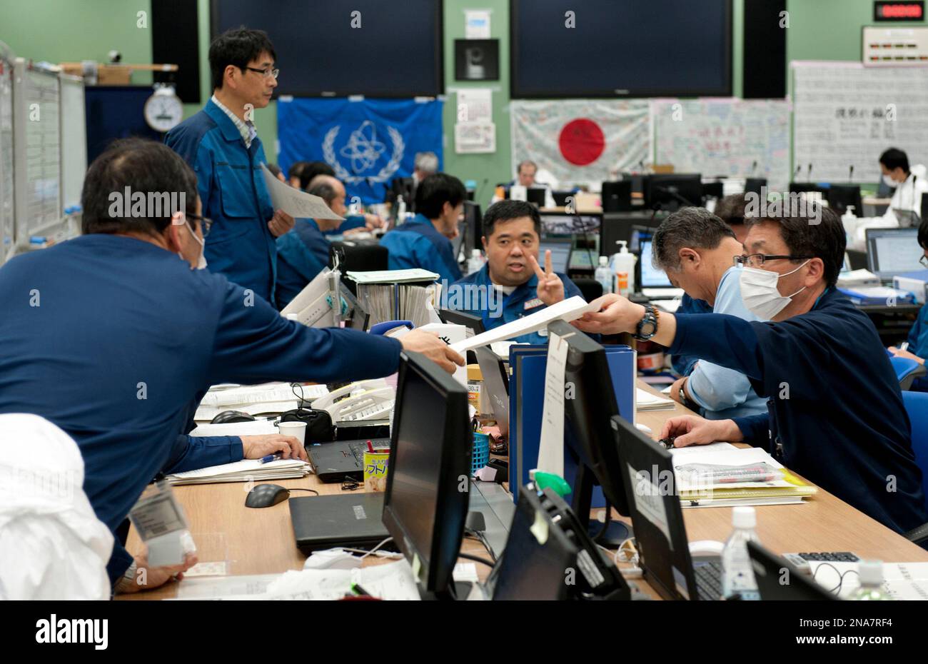 TEPCO workers are busy at the emergency operation center of Tokyo ...