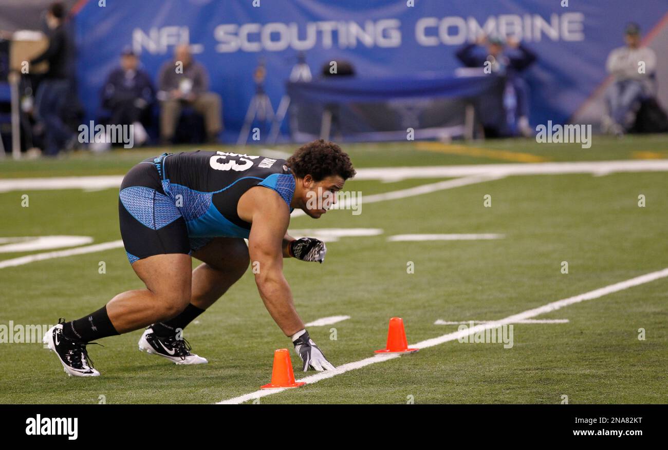 Michigan defensive lineman Mike Martin runs a drill at the NFL football ...