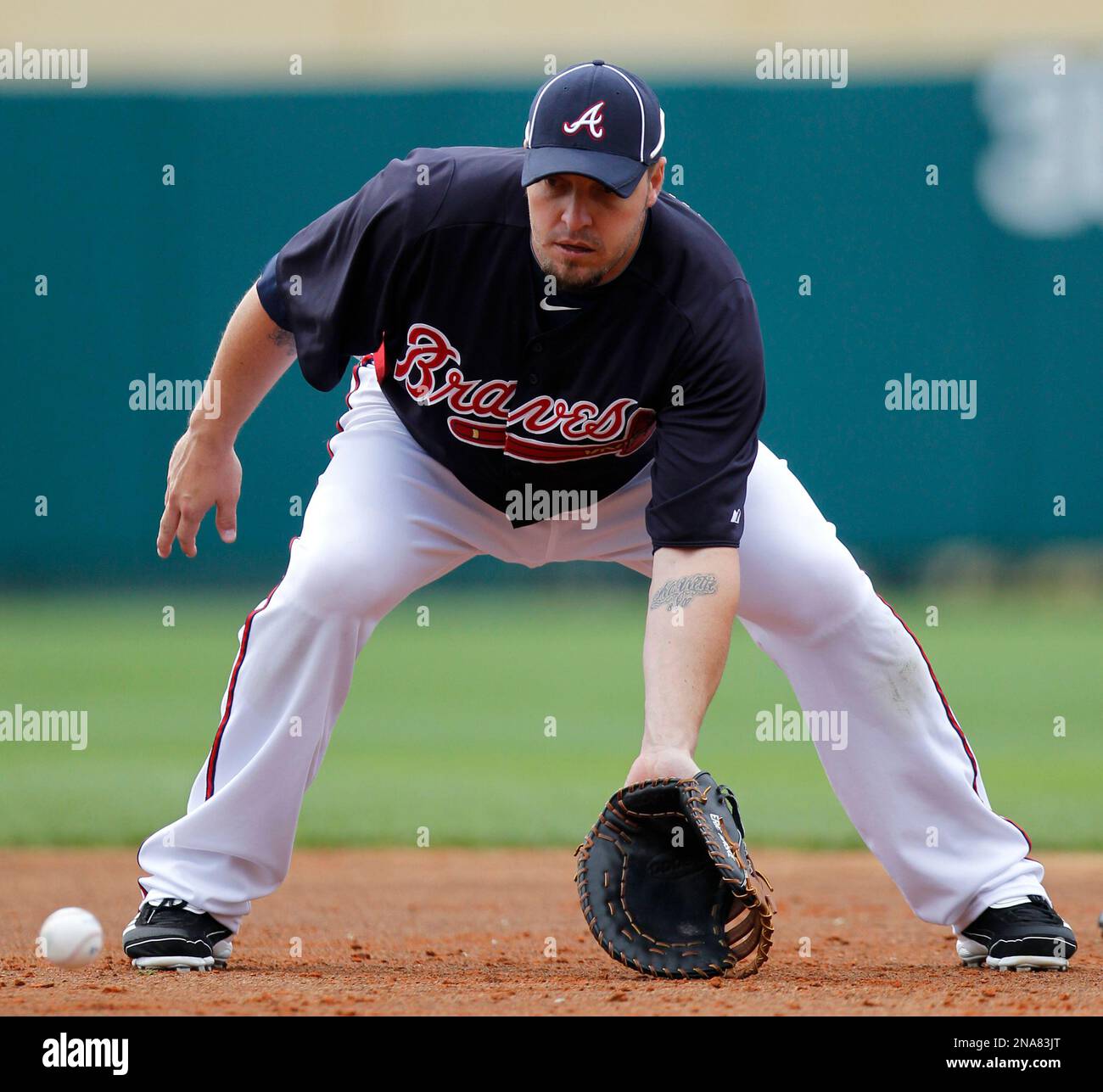 Atlanta Braves infielder Eric Hinske fields a ground ball during spring ...