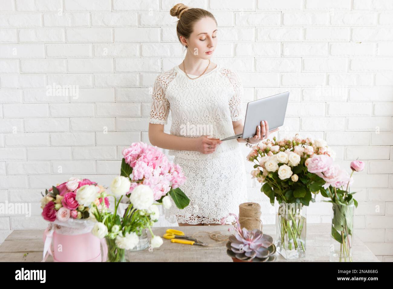 Florist check her order list before work Stock Photo - Alamy