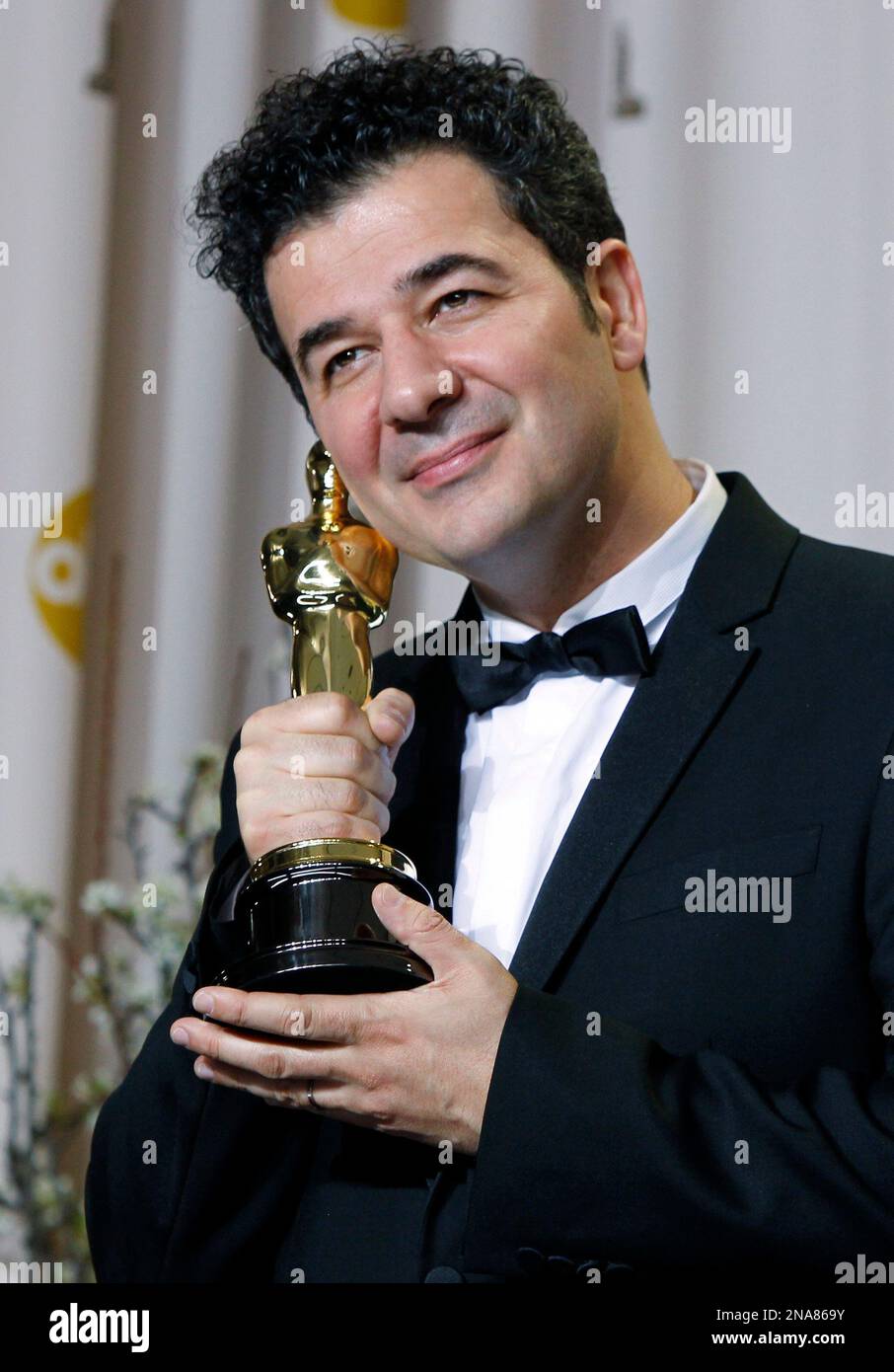 Ludovic Bource poses with his Oscar for best original score for his ...