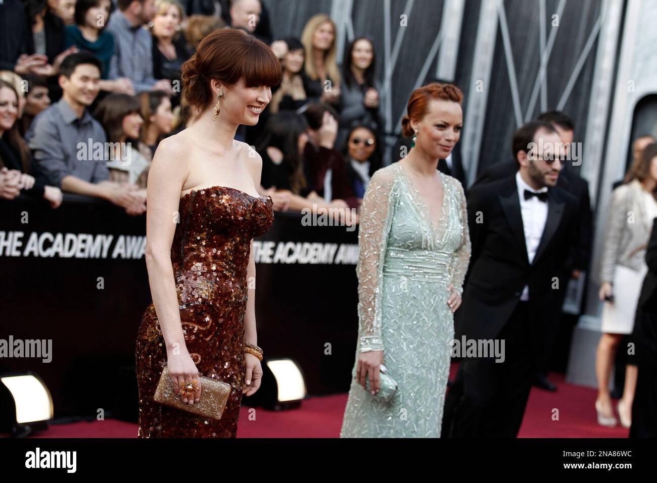 Ellie Kemper, left, and Berenice Bejo arrive before the 84th Academy ...
