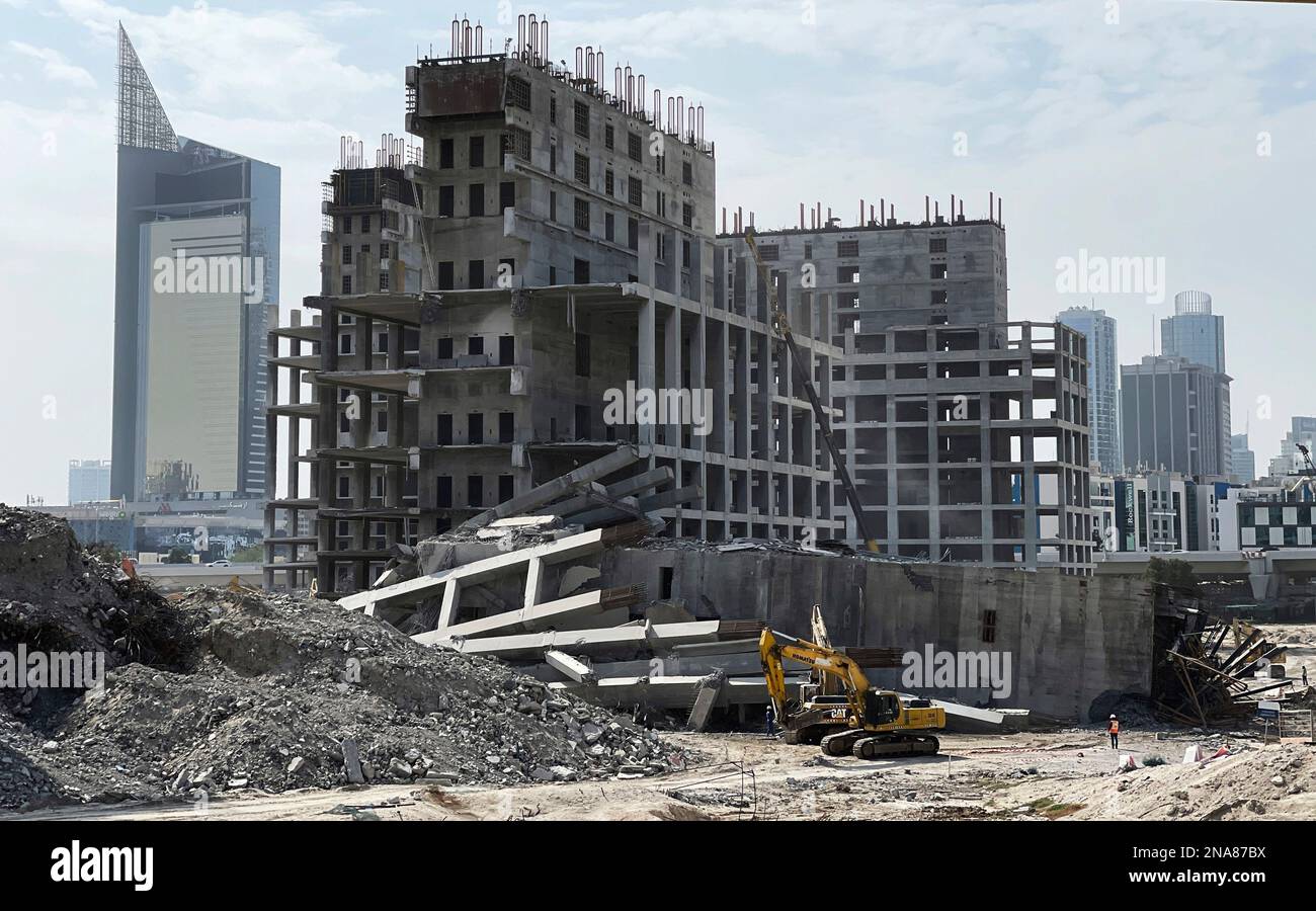 Workers demolish the abandoned Dubai Pearl high-rise project in Dubai ...