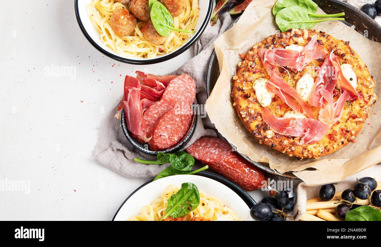 Full table of italian meals on plates and board - Pizza, pasta ...