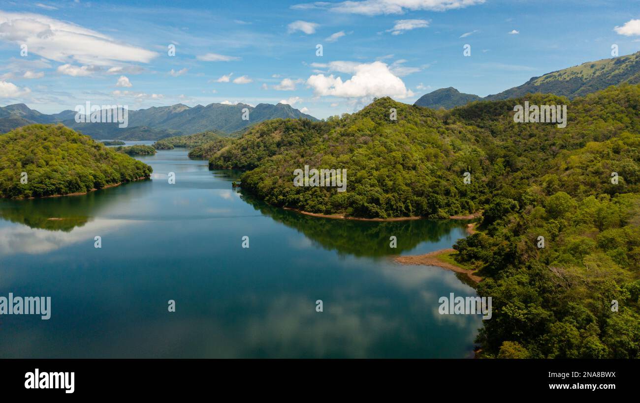 Aerial drone of river among mountains and hills with a forest against ...