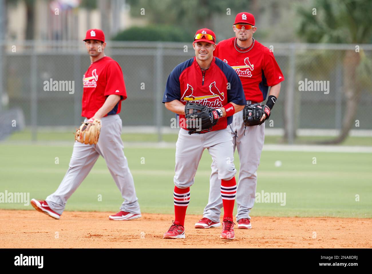 St. Louis Cardinals' Skip Schumaker, center, wait for a grounder along ...