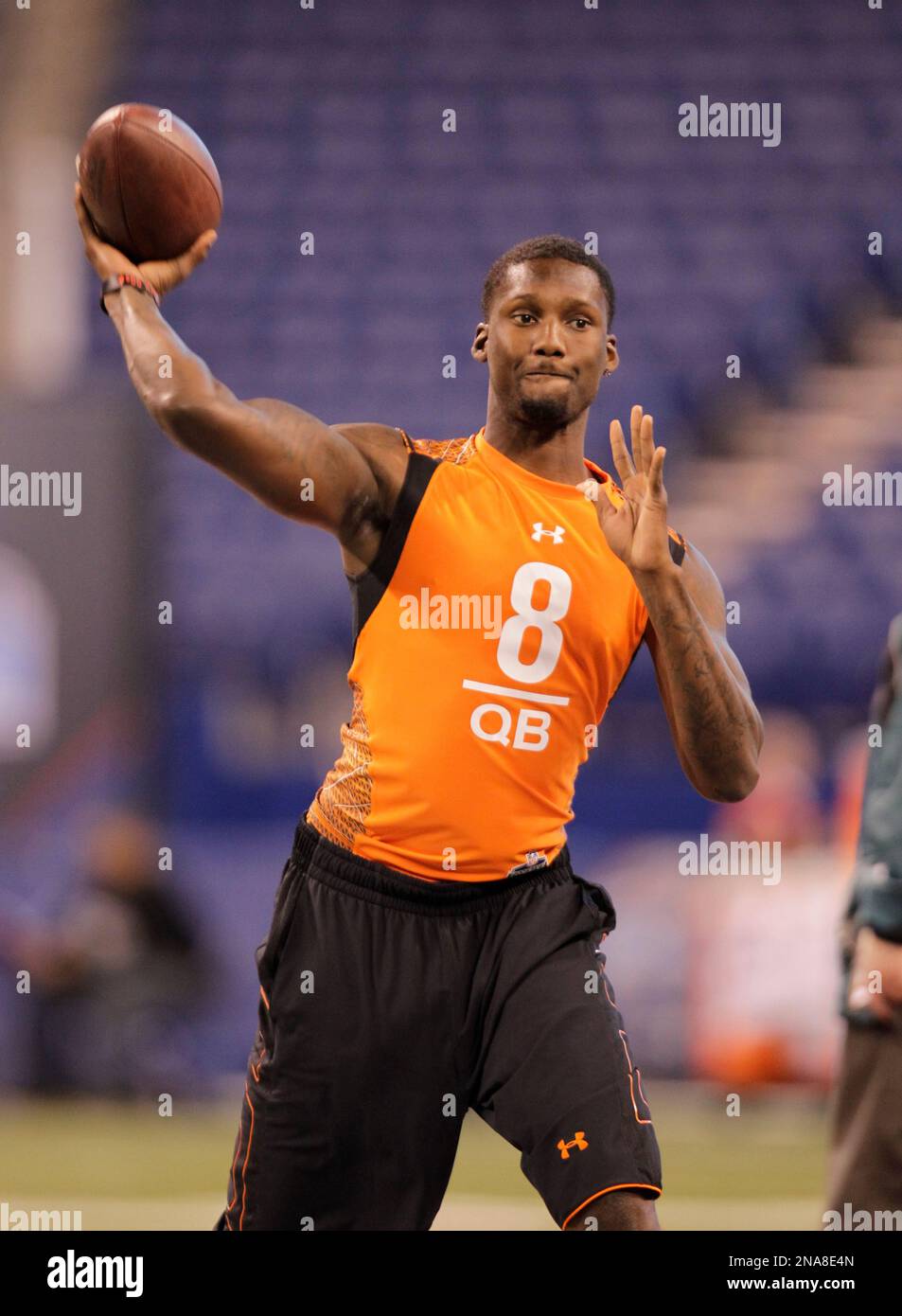 Miami quarterback Jacory Harris throws a pass as he runs a drill at the ...