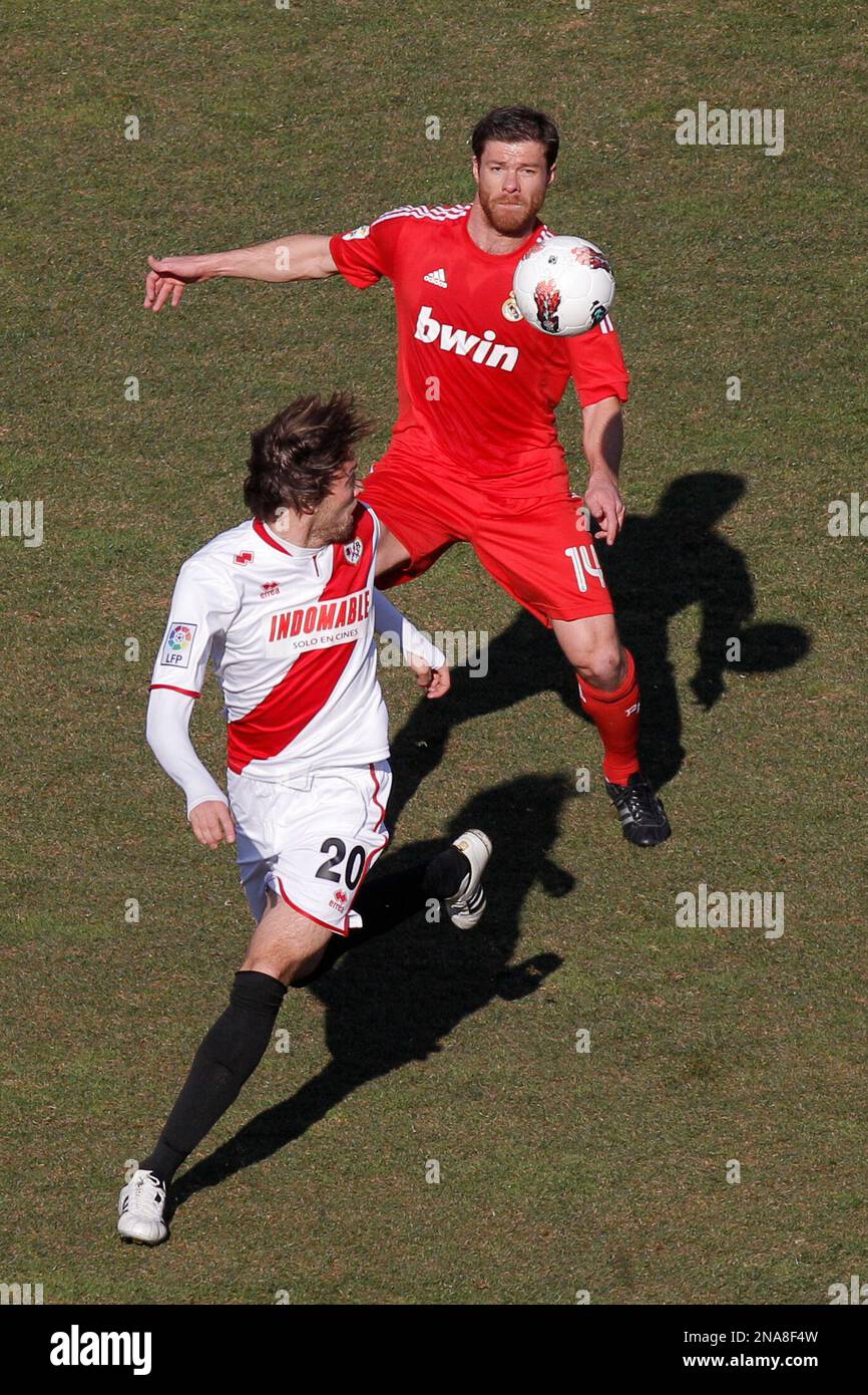 Real Madrid's Xabi Alonso, right, duels for the ball with Rayo ...