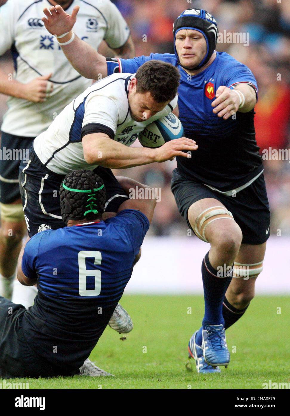 Scotland's Nick De Luca, center, is tackled by France's Thierry ...