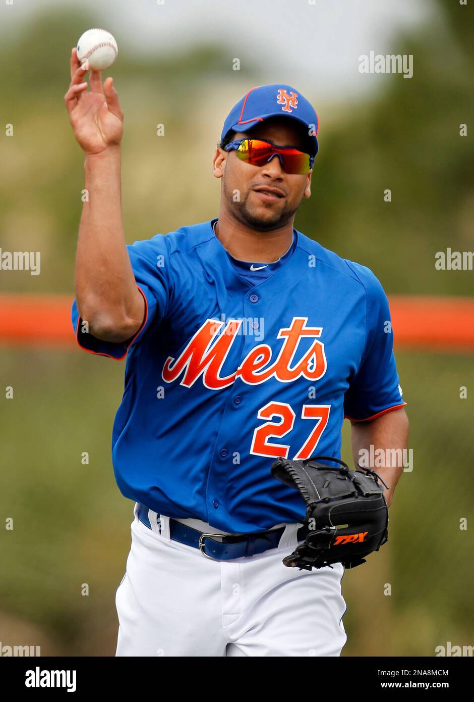 New York Mets pitcher Pedro Beato tosses a baseball to first bast ...