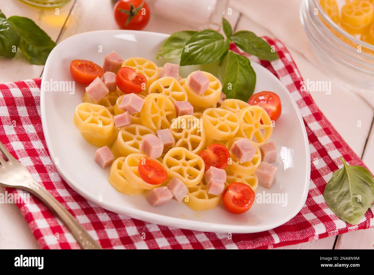 Ruote pasta with tomato and ham Stock Photo - Alamy