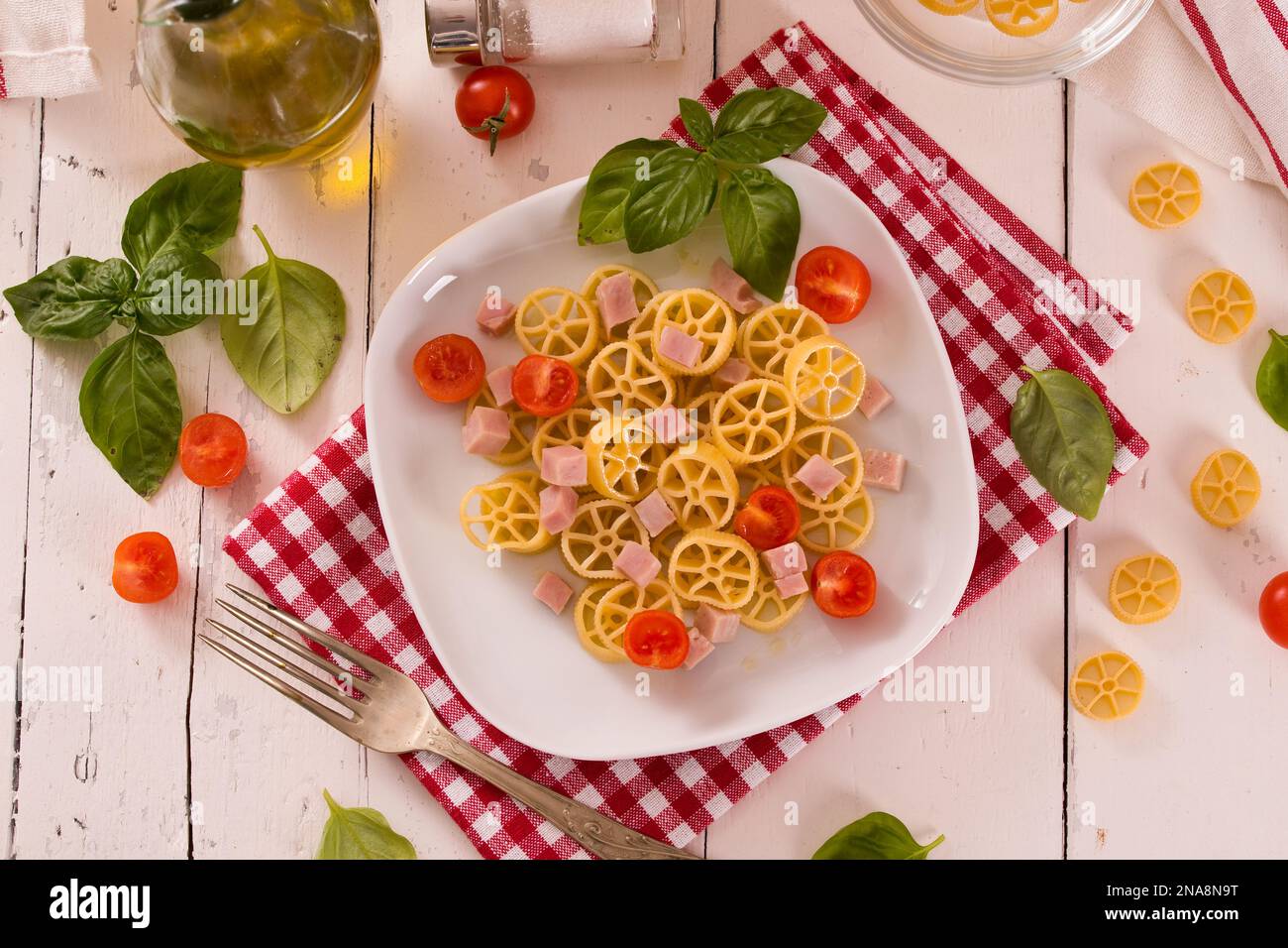 Ruote pasta with tomato and ham Stock Photo - Alamy