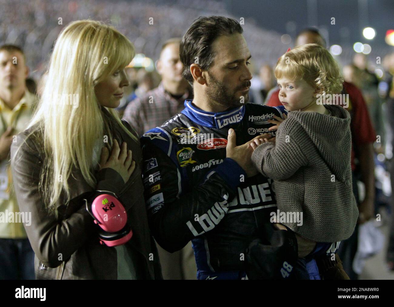 Jimmie Johnson, center, stands on pit road with his wife Chandra, left ...