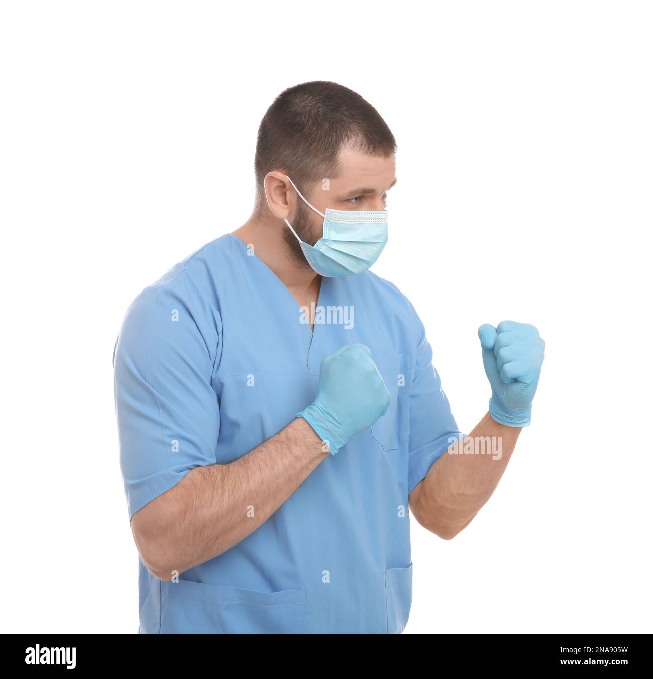 Doctor with protective mask in fighting pose on white background ...
