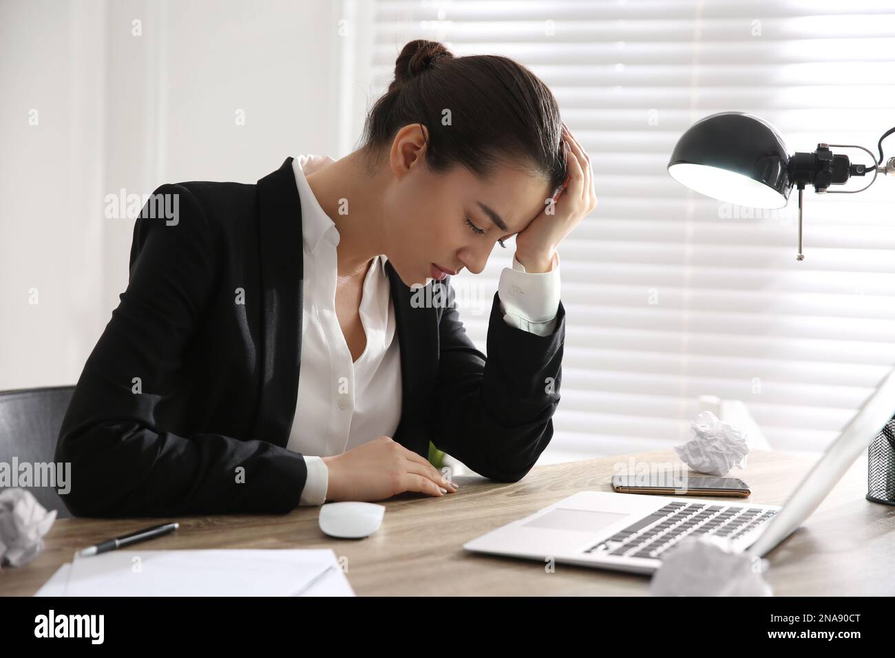 Stressed and tired young woman at workplace Stock Photo - Alamy