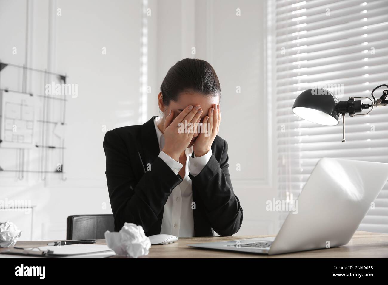 Stressed and tired young woman at workplace Stock Photo - Alamy