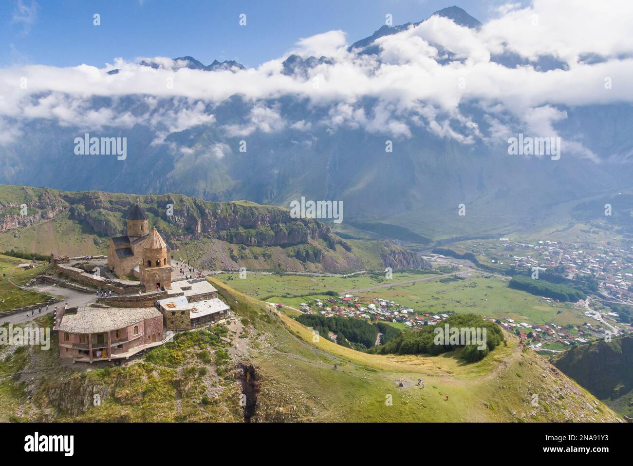 Aerial view of Gergeti Trinity Church, overlooking the towns of Gergeti ...