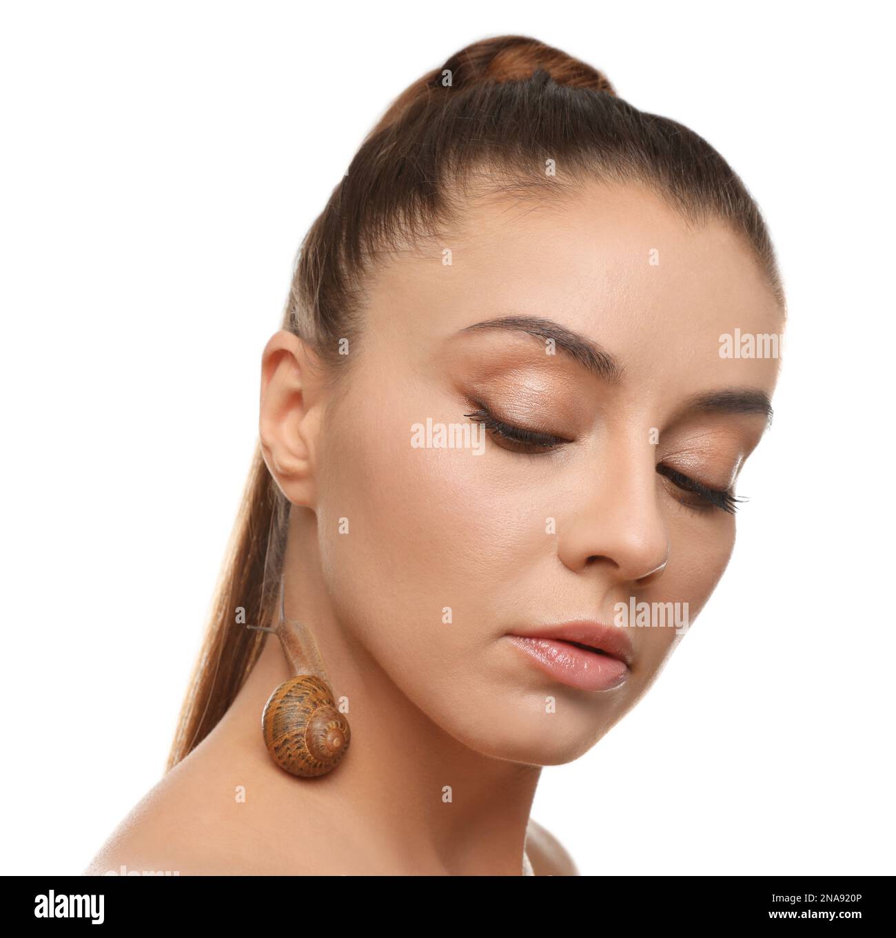 Beautiful young woman with snail on her neck against white background ...