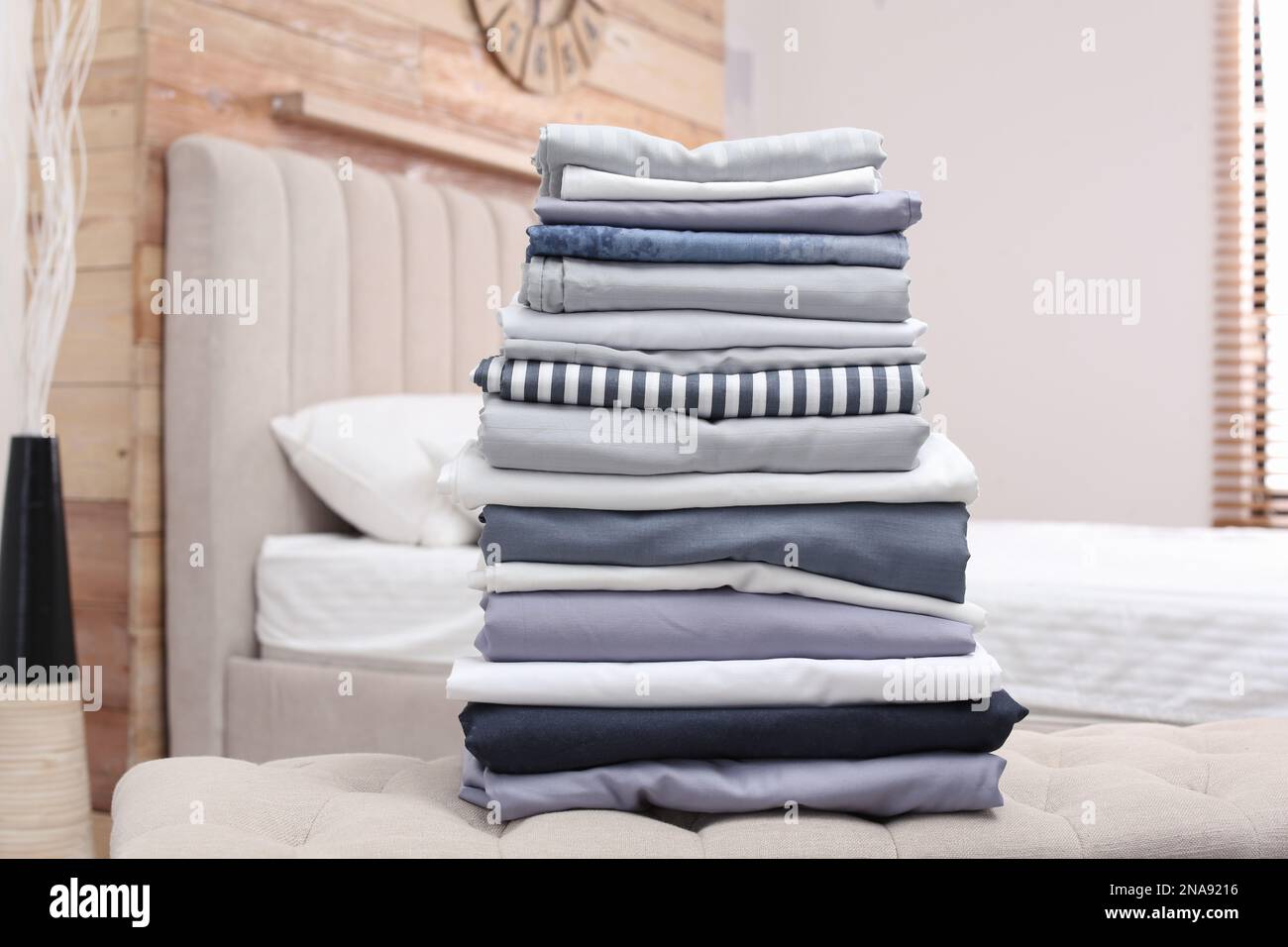 Stack of clean bed linens in bedroom Stock Photo - Alamy