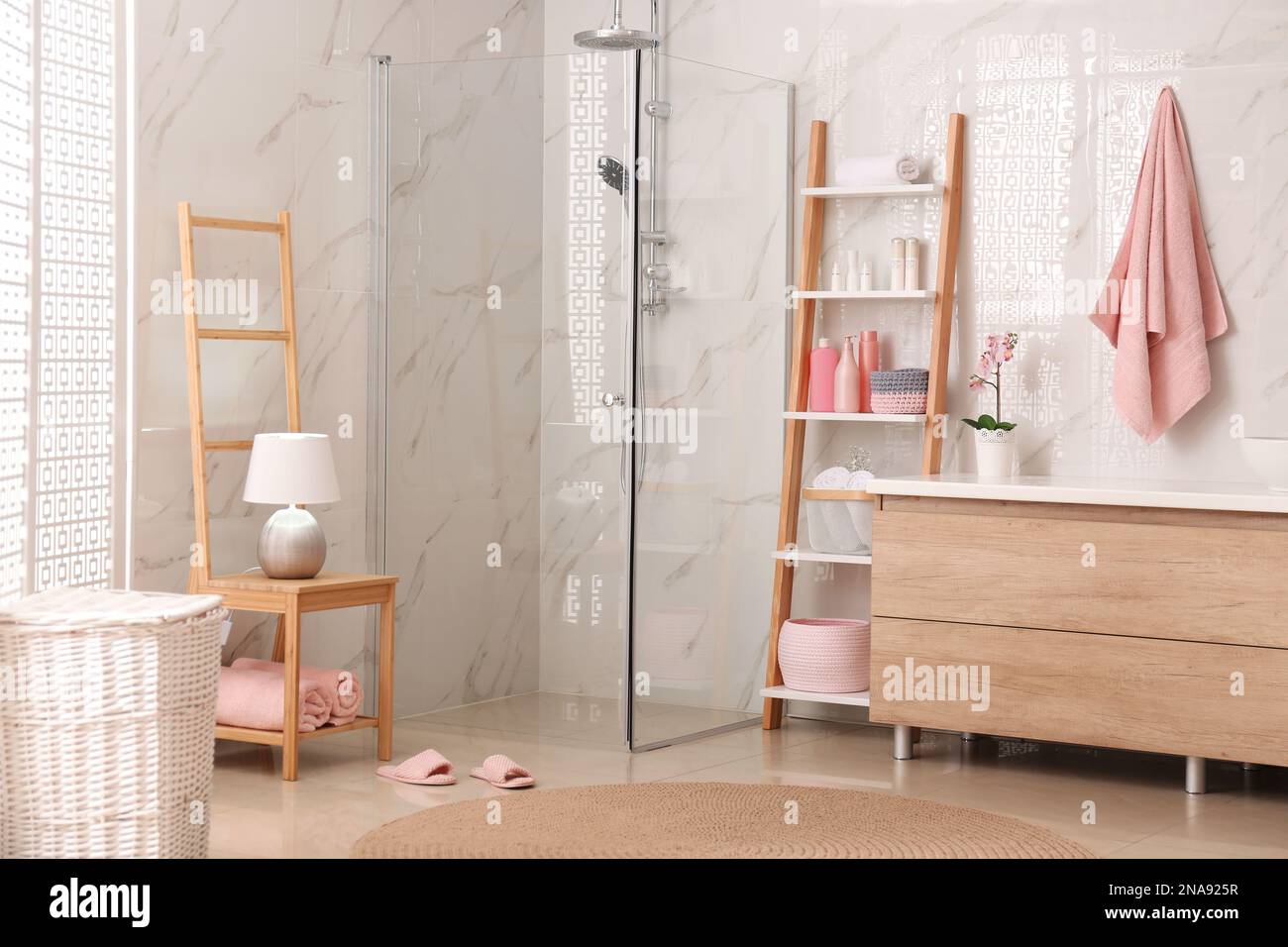Modern bathroom interior with decorative ladder and shower stall Stock ...