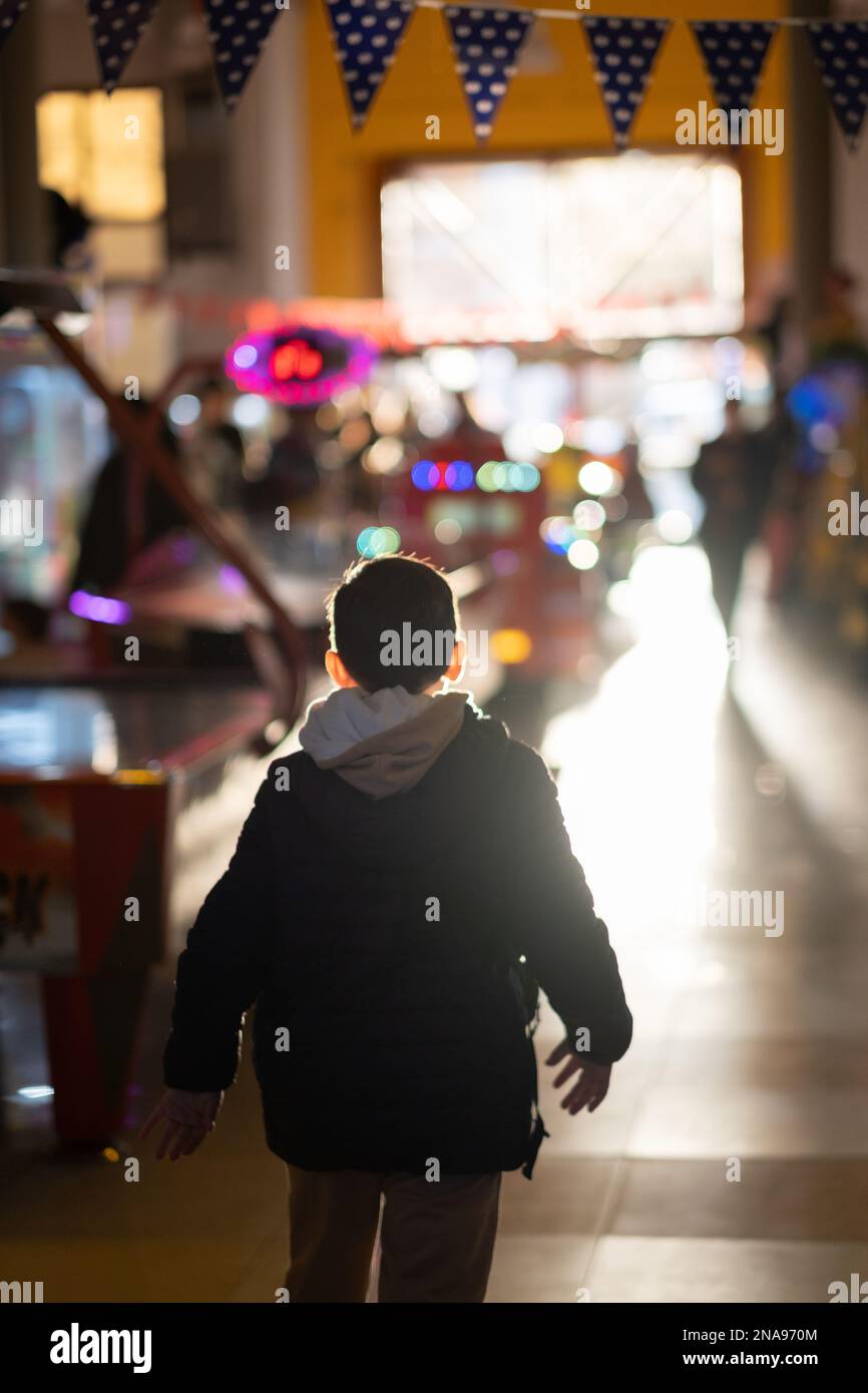A back view of Caucasian boy walking in street Stock Photo - Alamy