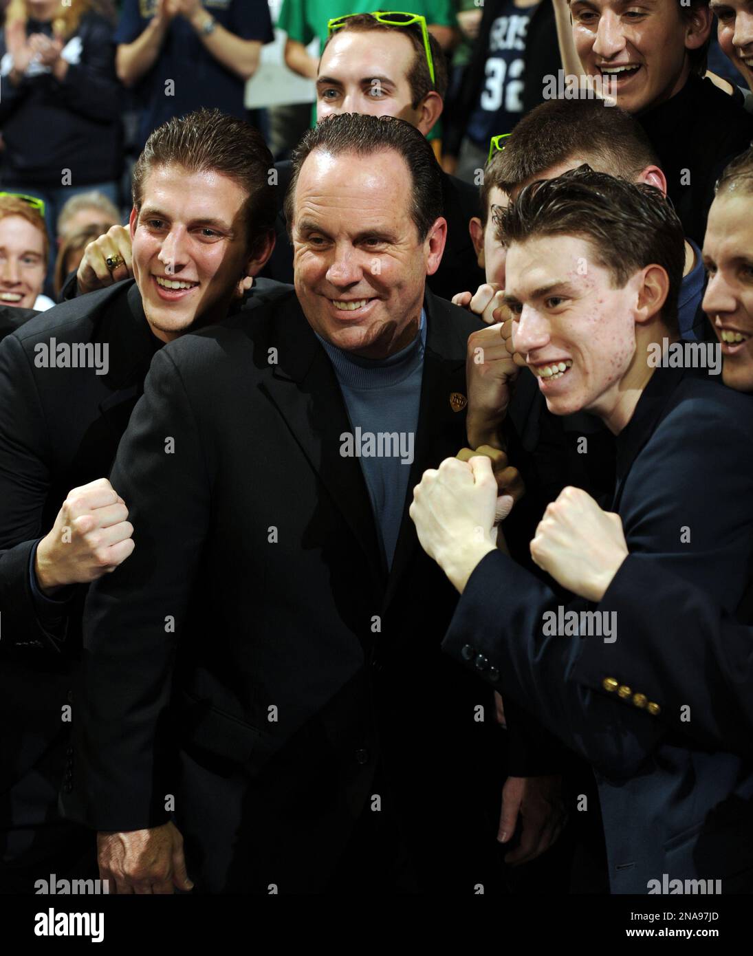 Notre Dame coach Mike Brey poses with students dressed similiar to Brey ...